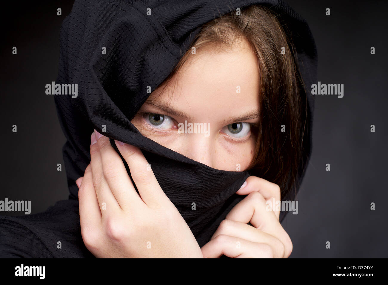 Beautiful woman hiding her face by black headscarf Stock Photo - Alamy