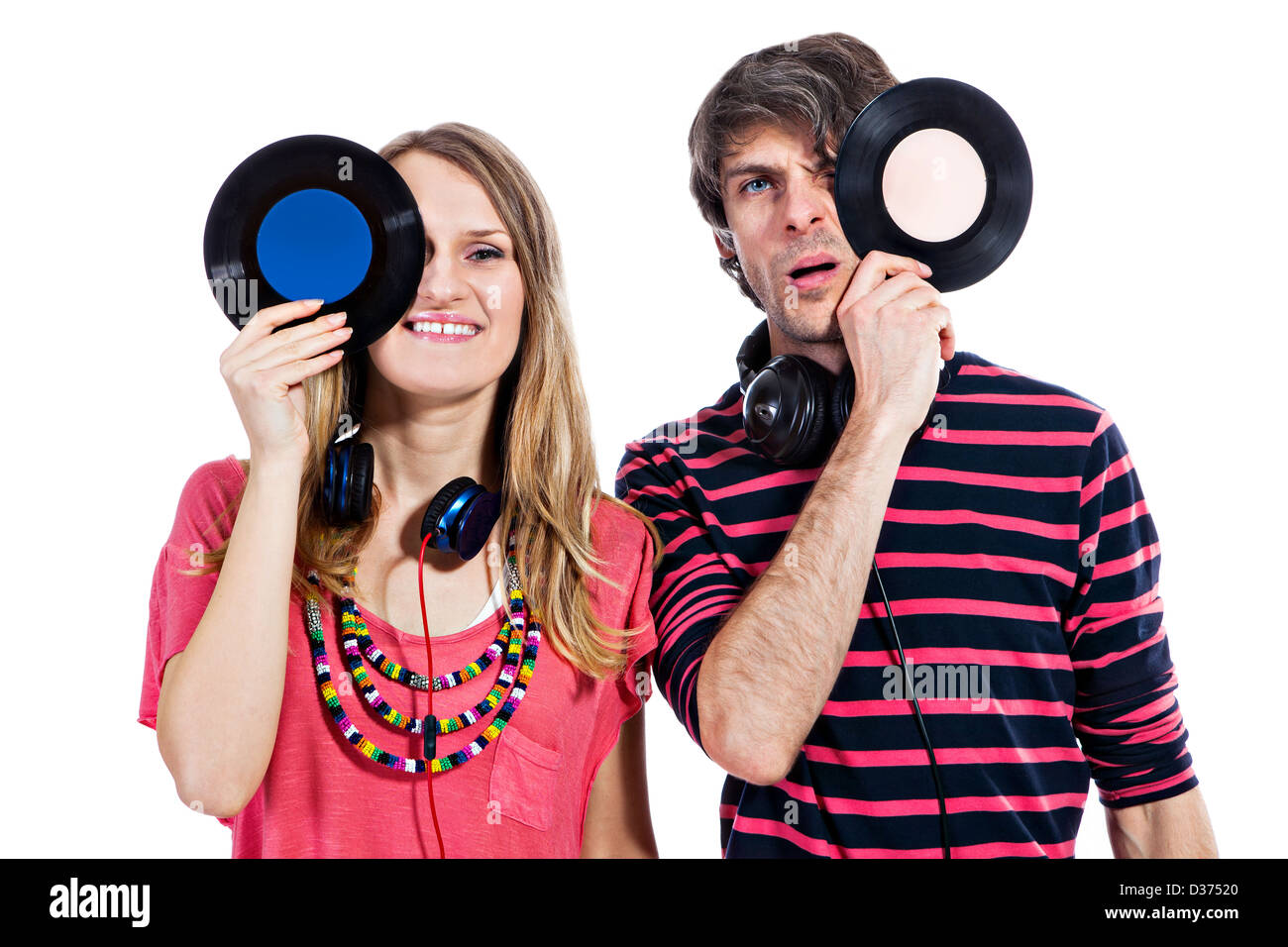 Happy young couple playing around with vinyl records isolated on a ...