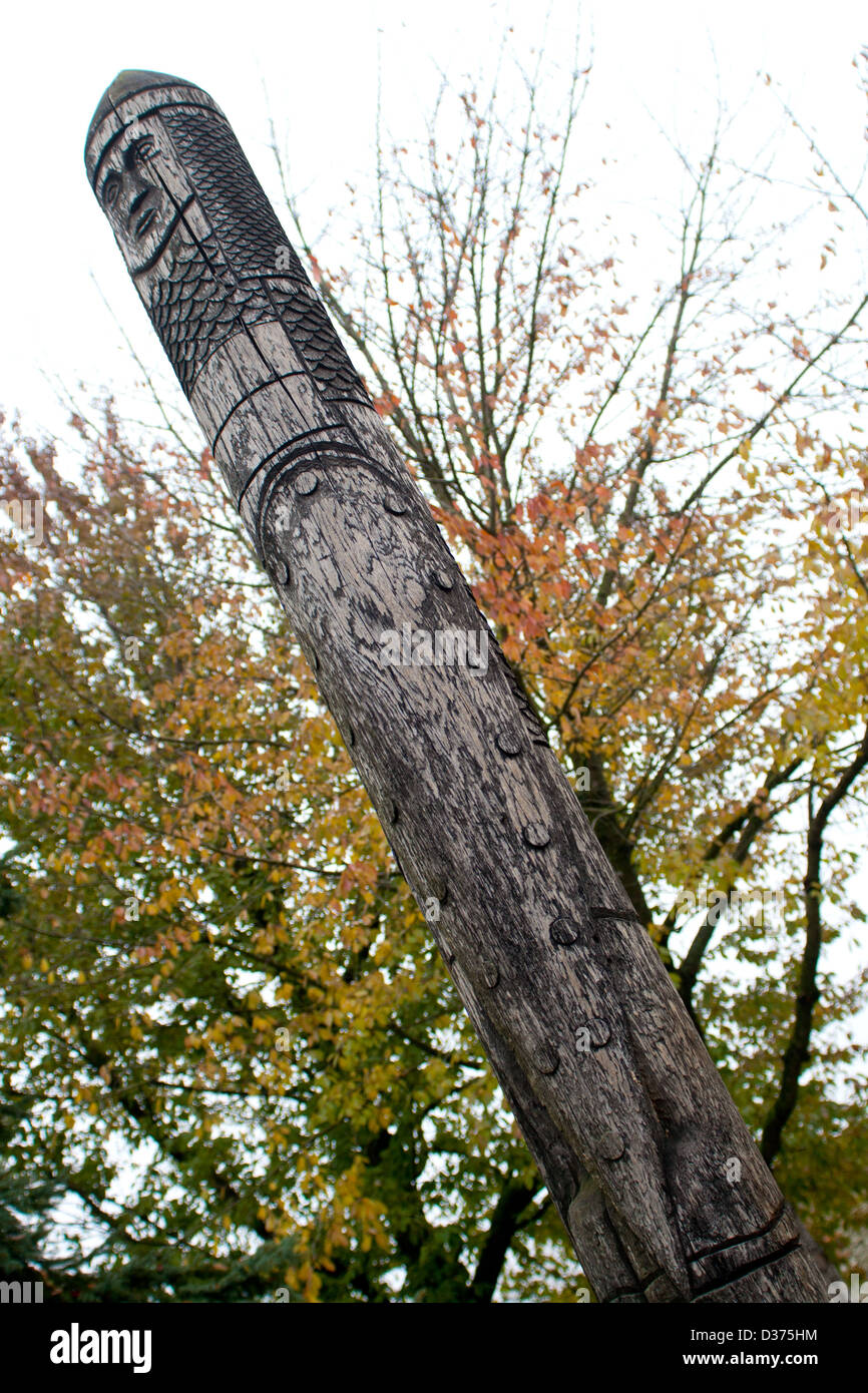 ancient wooden pole with a cut on it depicting ancient deities located ...