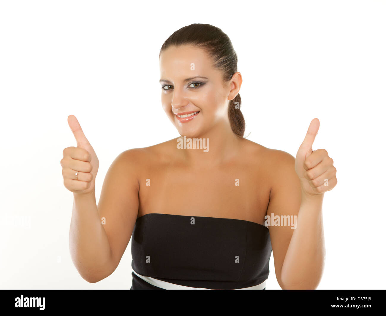 Attractive young brunette businesswoman shows the sign thumbs up ...