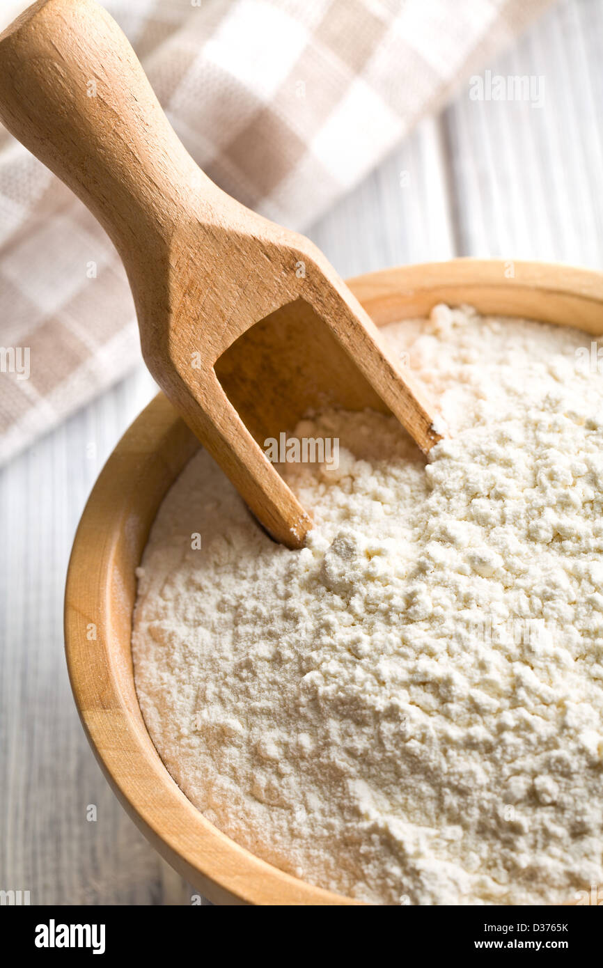 flour in wooden bowl on kitchen table Stock Photo - Alamy