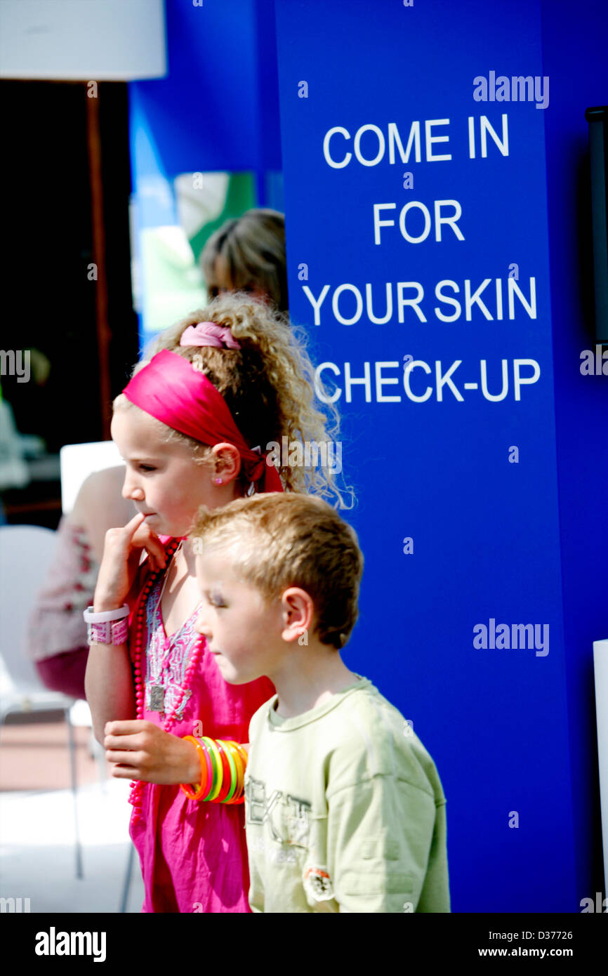 Young children watching a skin check up out of shot Stock Photo - Alamy