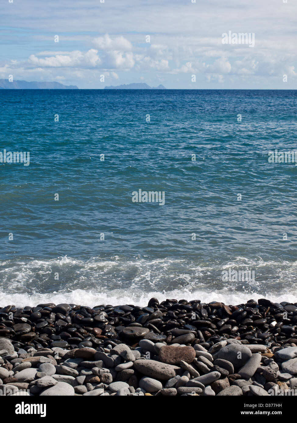 Blue ocean and rocky beach Stock Photo - Alamy