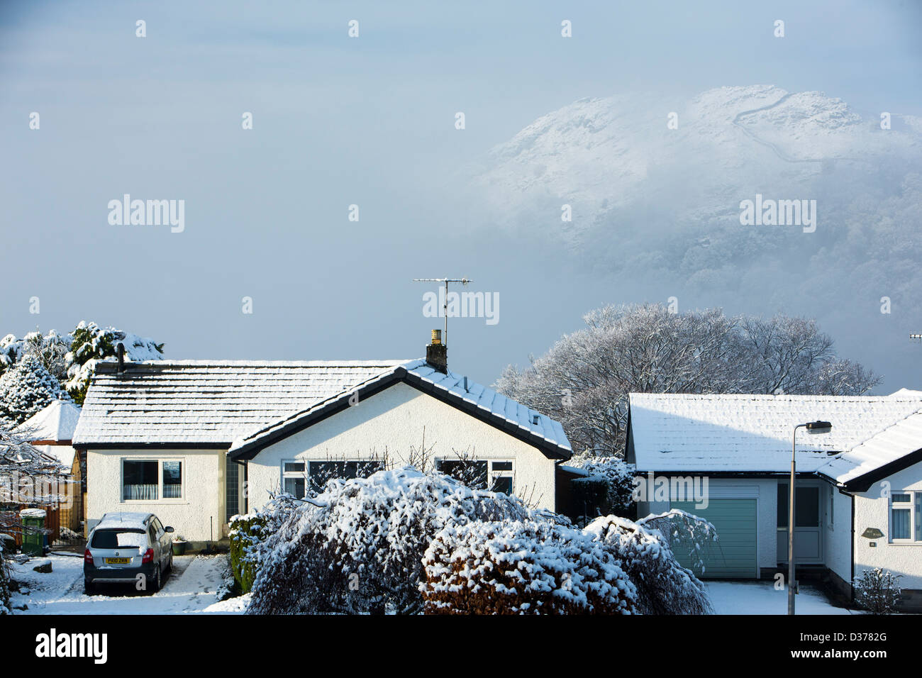 Mountains appearing through clearing mist over houses in Ambleside ...