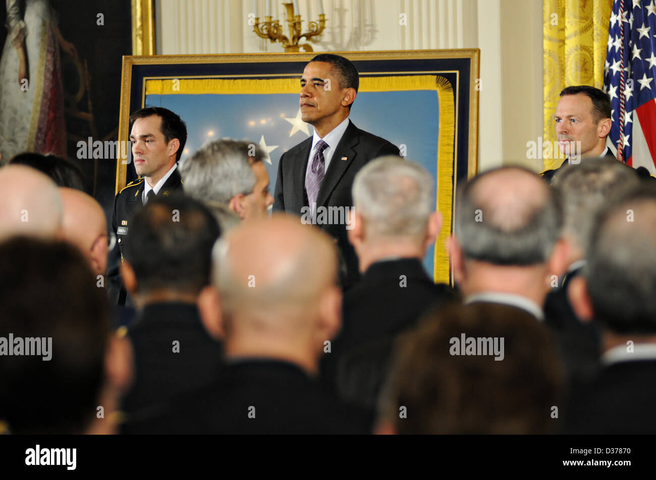 US President Barack Obama stands at attention with Army Staff Sergeant ...