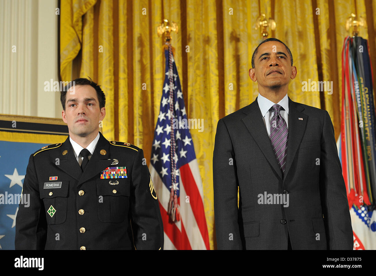 US President Barack Obama stands at attention with Army Staff Sergeant ...