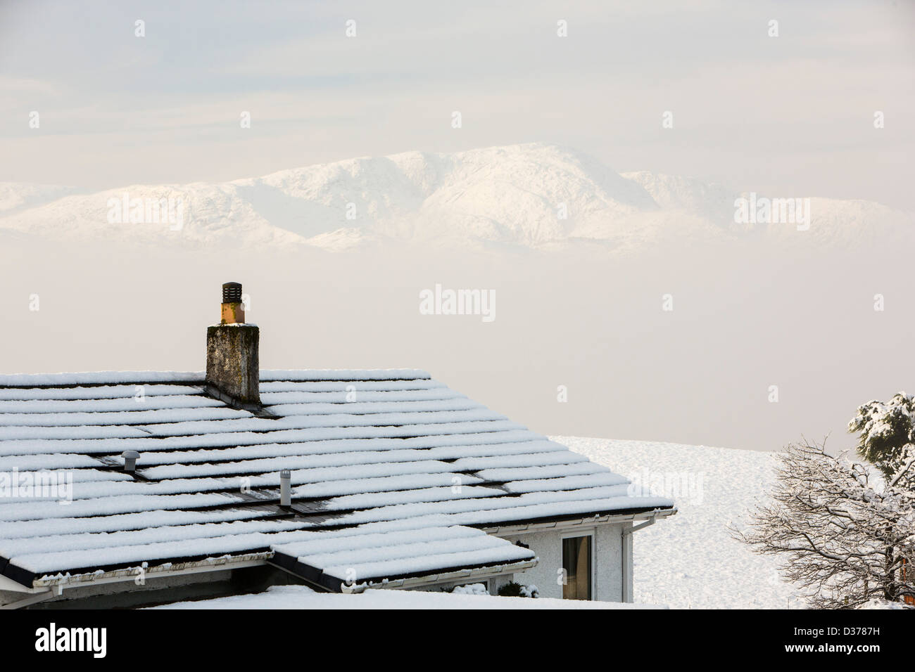Mountains appearing through clearing mist over houses in Ambleside ...
