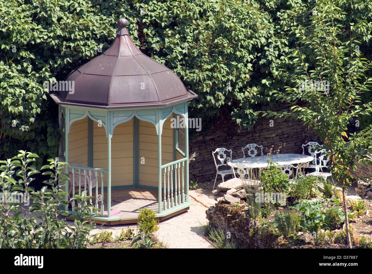 UK. A rotating garden gazebo next to table and chairs Stock Photo - Alamy