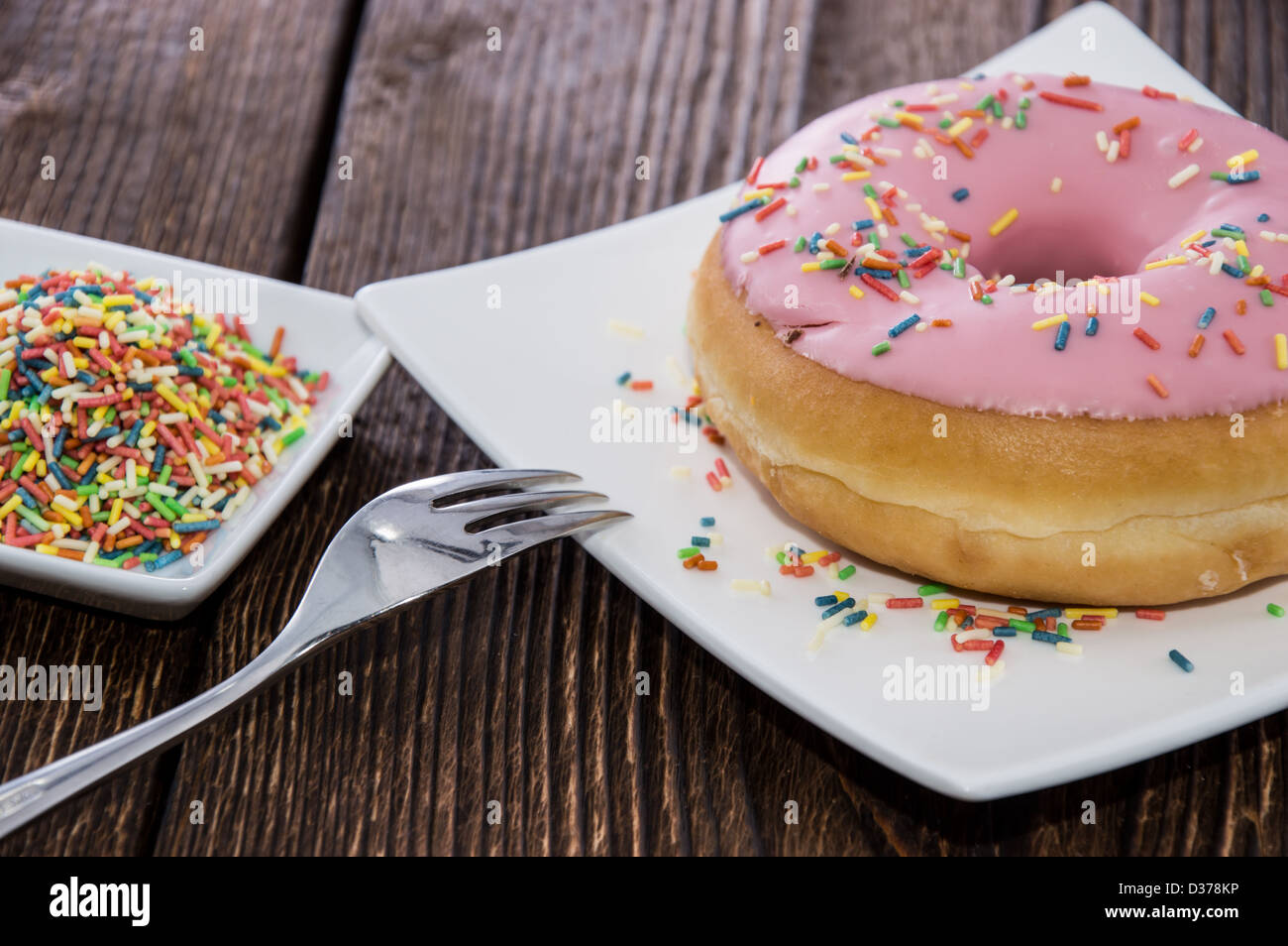 Single Pink Donut on a plate (wooden background Stock Photo - Alamy