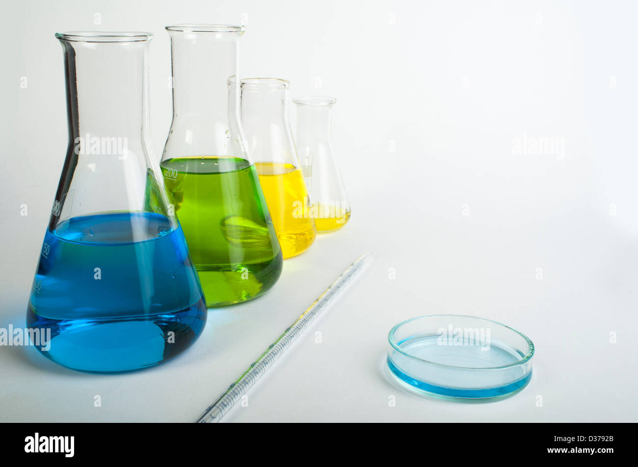 Laboratory glassware equipment. Laboratory beakers filled with colored ...