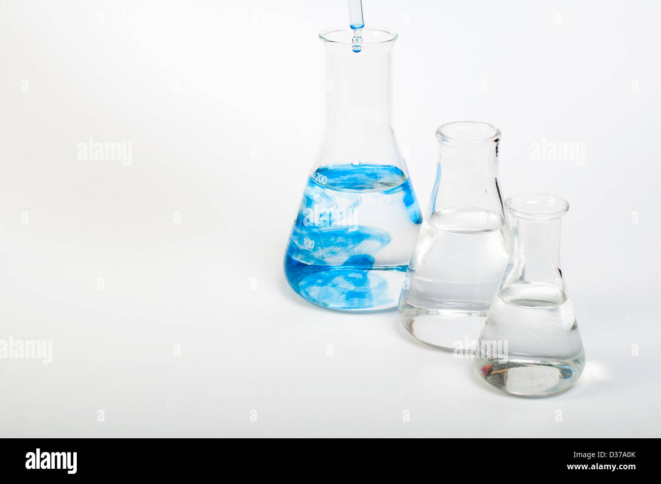 Laboratory equipment and color chemicals on white background Stock ...
