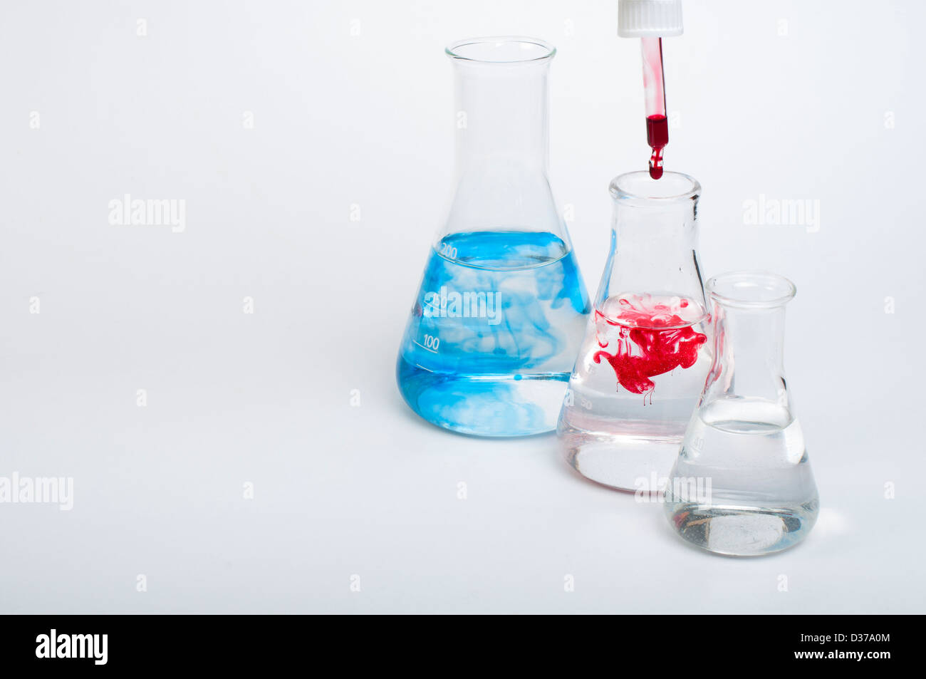 Laboratory equipment and color chemicals on white background Stock ...