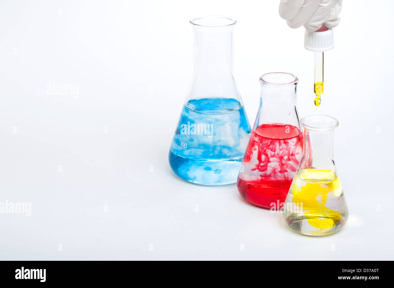 Laboratory equipment and color chemicals on white background Stock ...