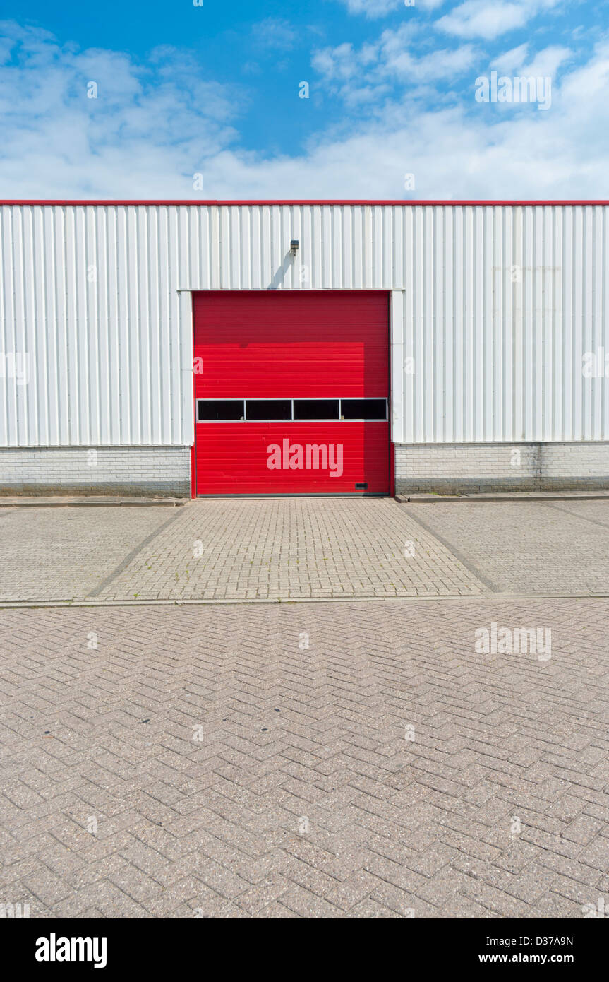 industrial warehouse with red roller door Stock Photo - Alamy