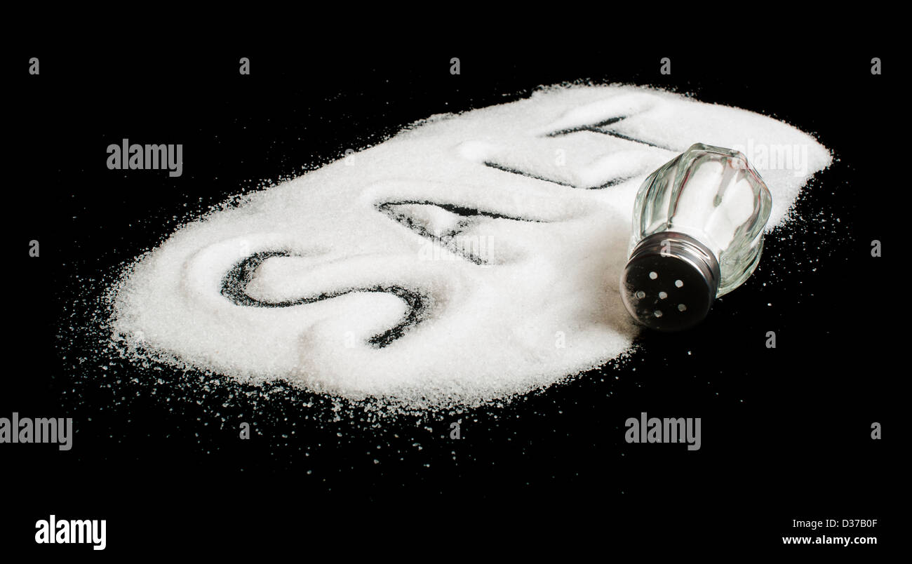 Word Salt on black background written by spilled salt Stock Photo - Alamy