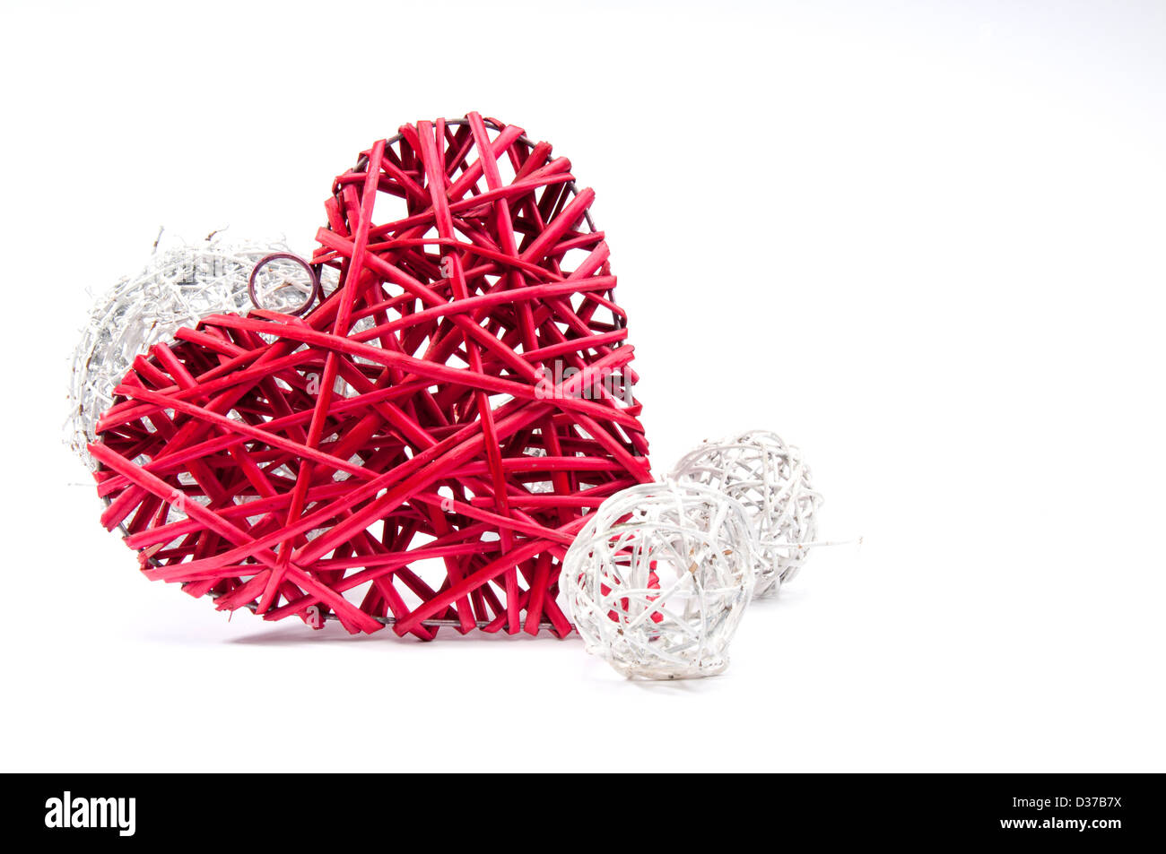 Red wicker heart with white wicker balls Stock Photo - Alamy