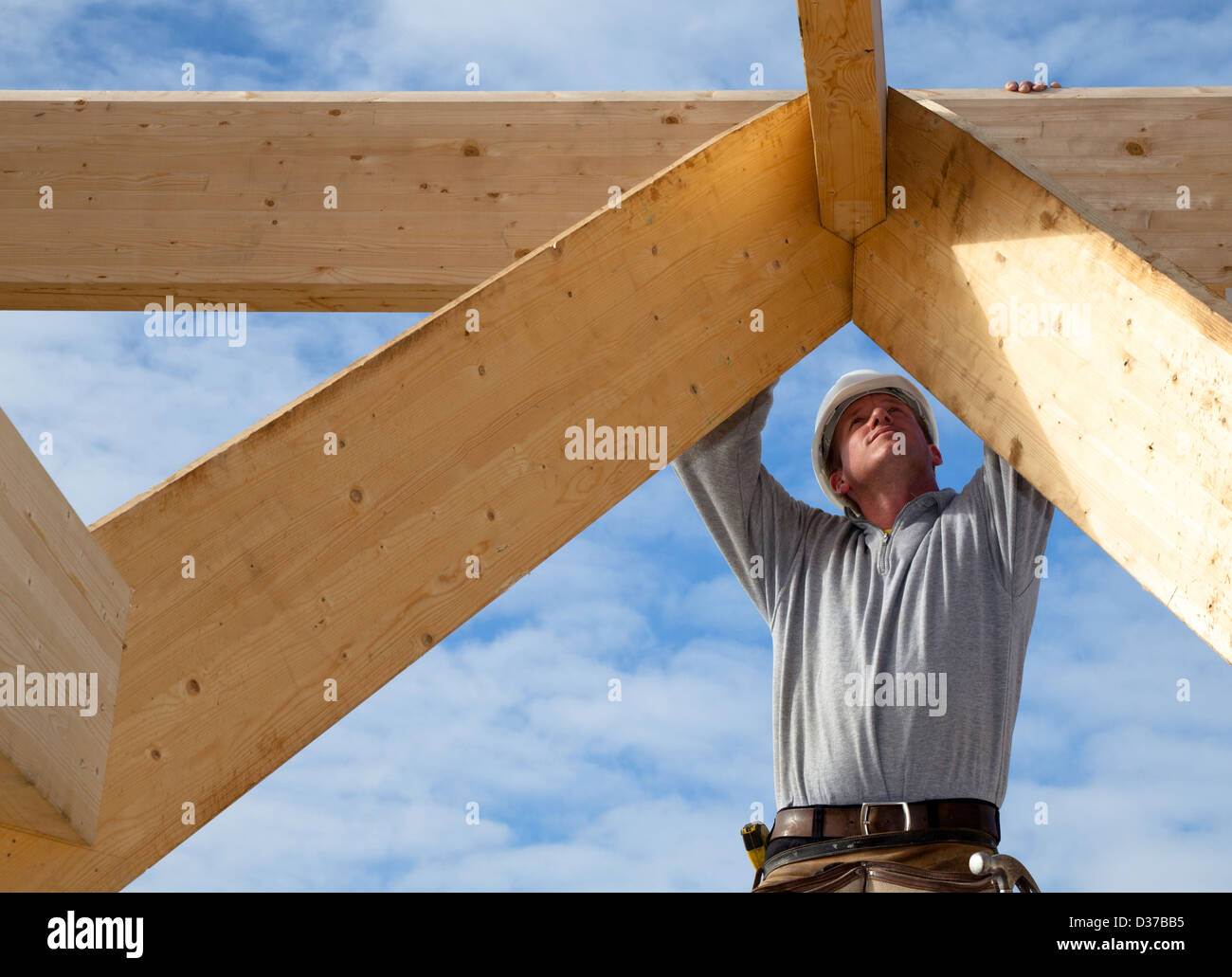 real builder at work on construction site. making a roof Stock Photo ...