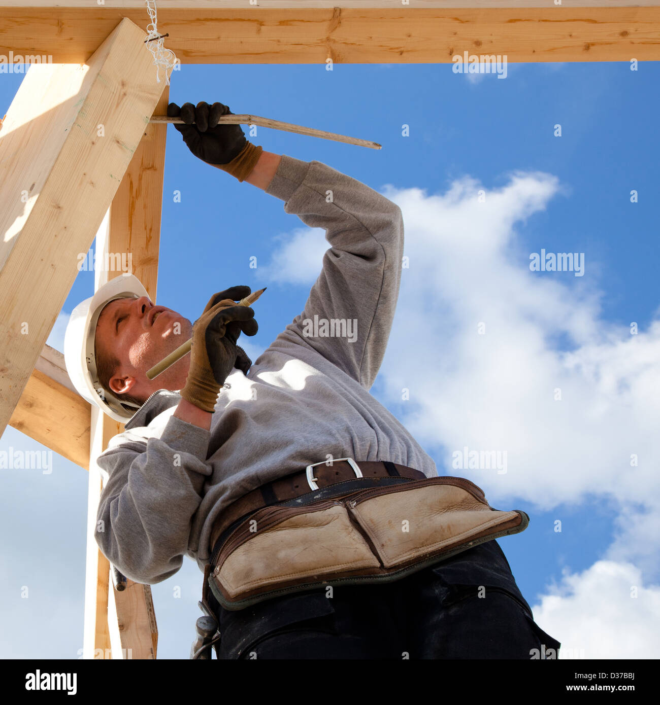 real builder at work on construction site. making a roof Stock Photo ...