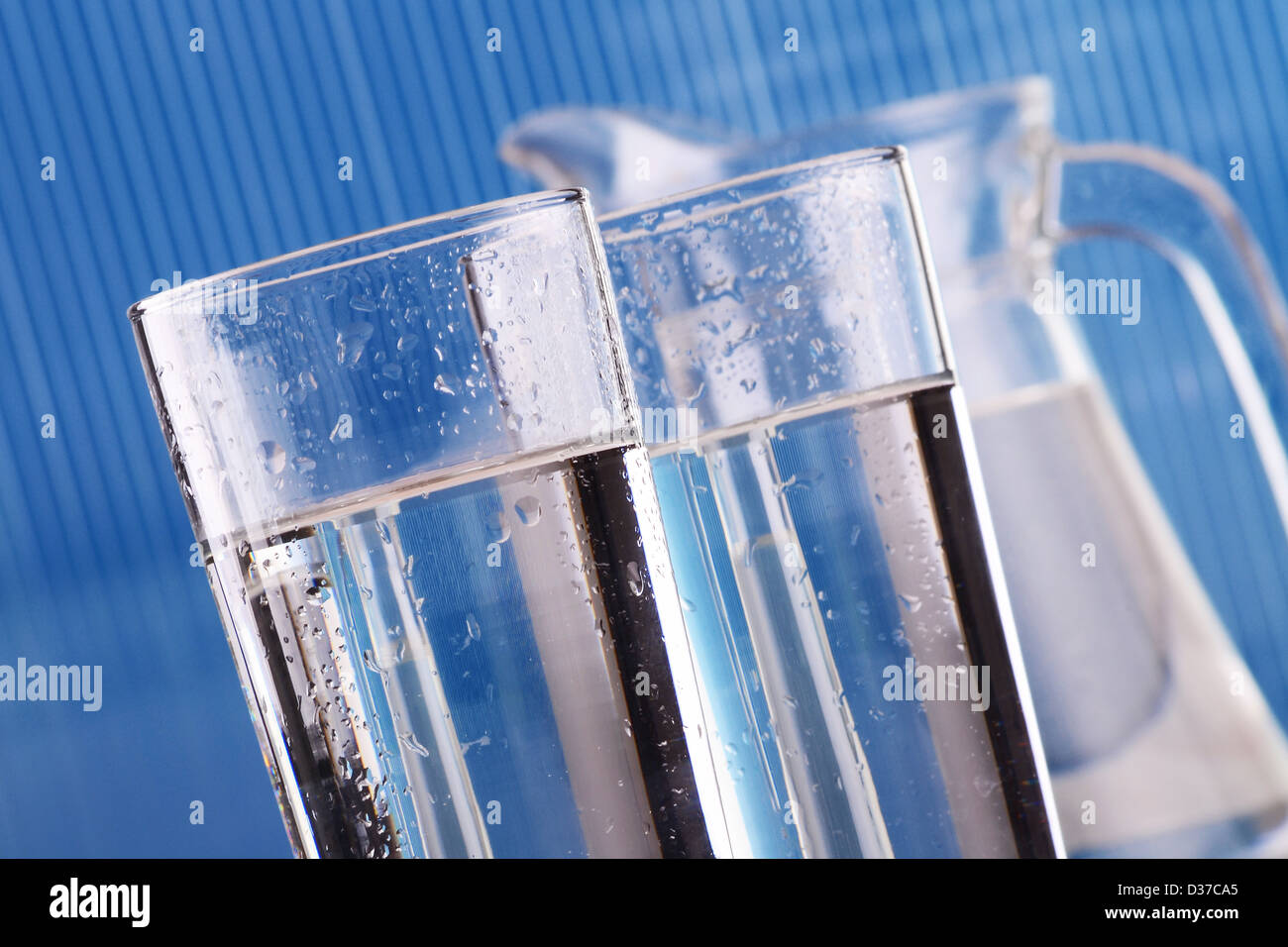 Composition with two glasses of water on blue background Stock Photo ...