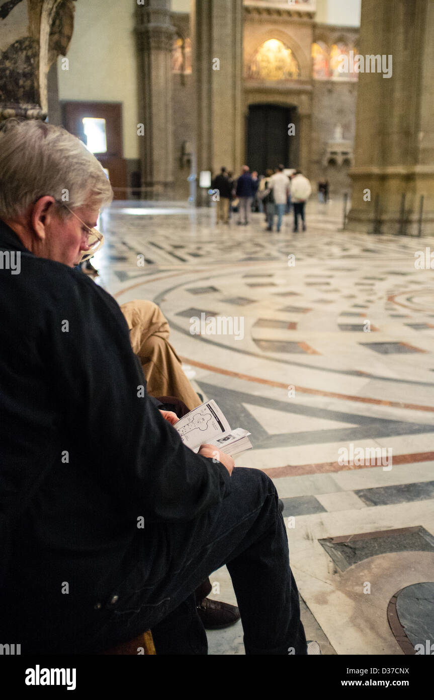 Man reading a guide book inside the Basilica di Santa Maria del Fiore ...
