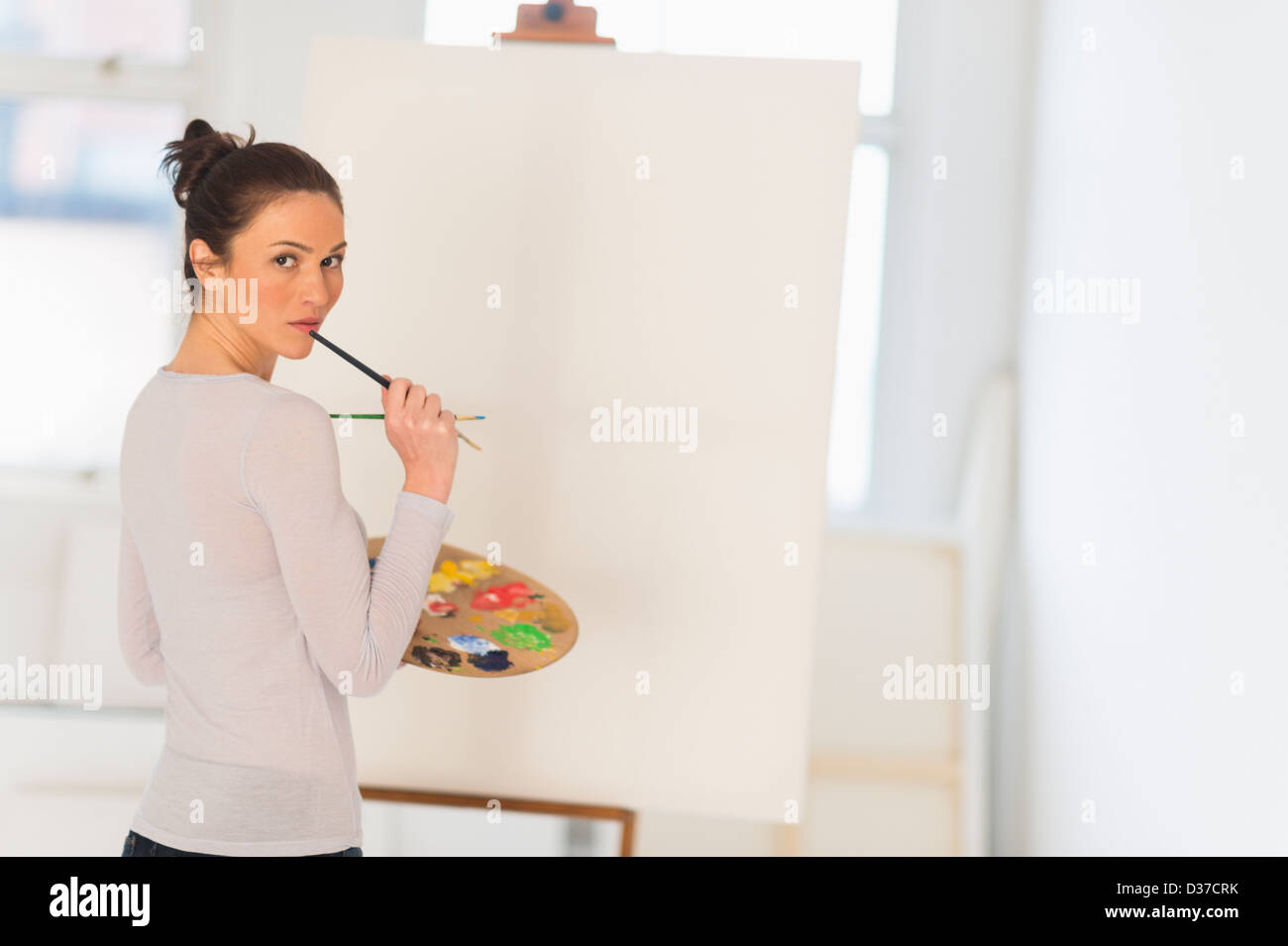 Woman painting looking over shoulder hi-res stock photography and ...