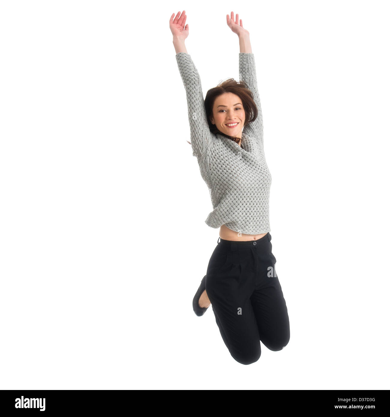 Studio portrait of mid adult woman jumping Stock Photo - Alamy