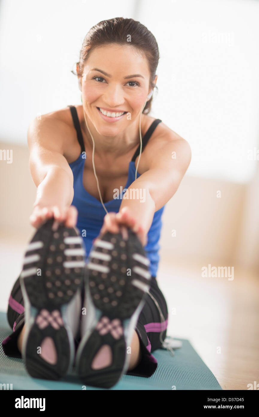 USA, New Jersey, Jersey City, Portrait of woman stretching in gym Stock ...