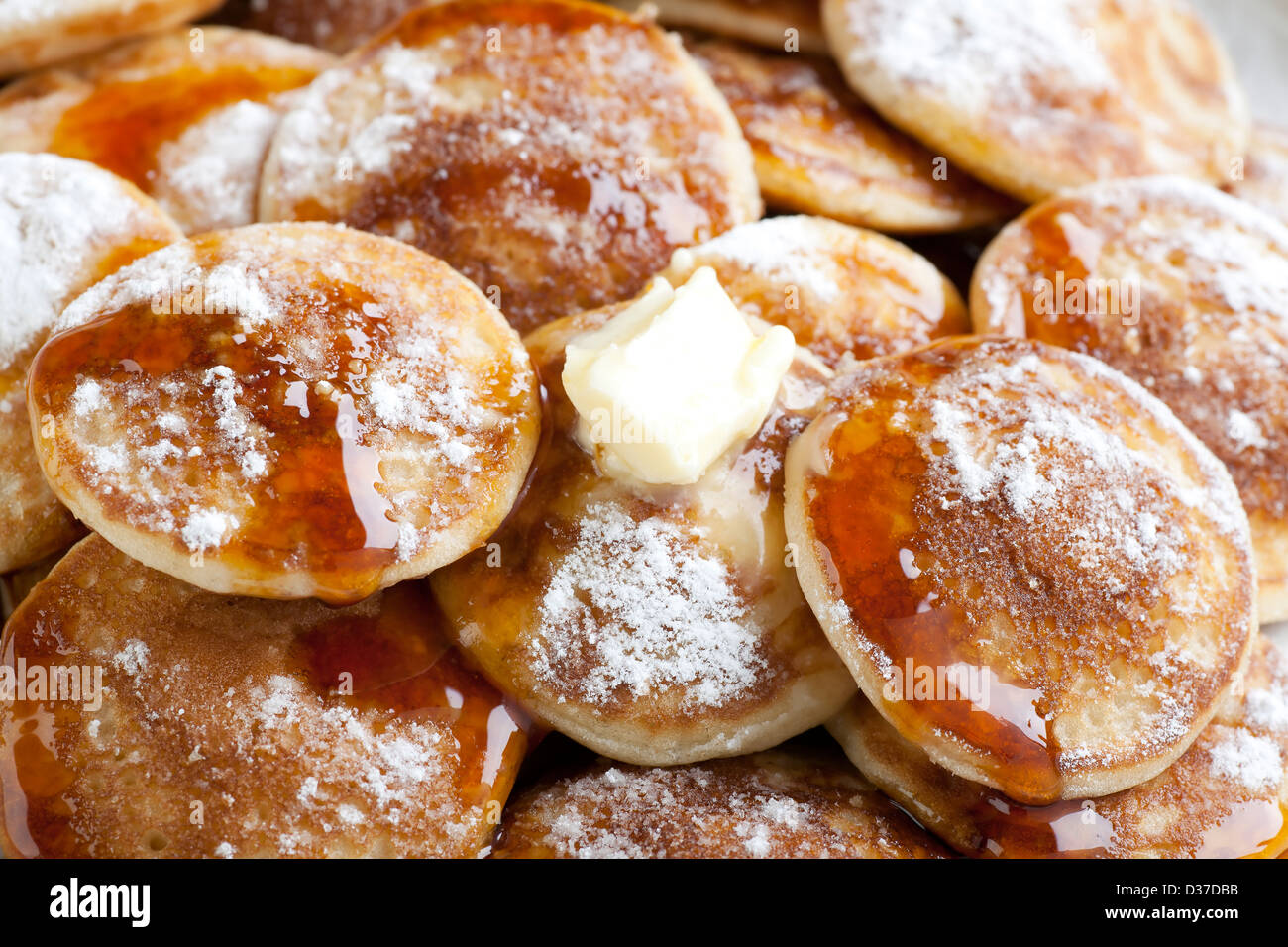 Dutch mini pancakes, or poffertjes, with butter, syrup and powdered ...