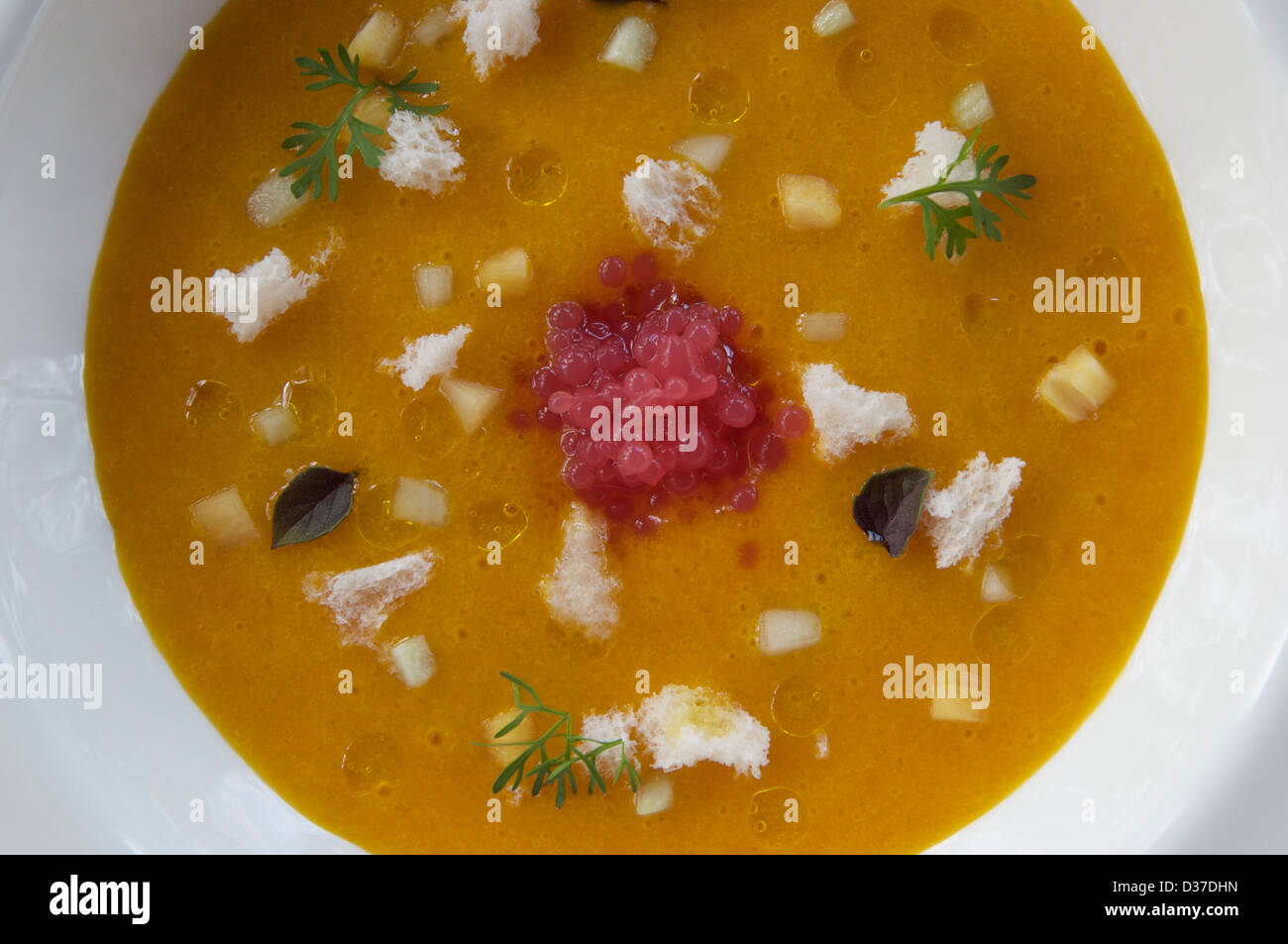 Mango gazpacho with watermelon caviar served in a white bowl Stock ...