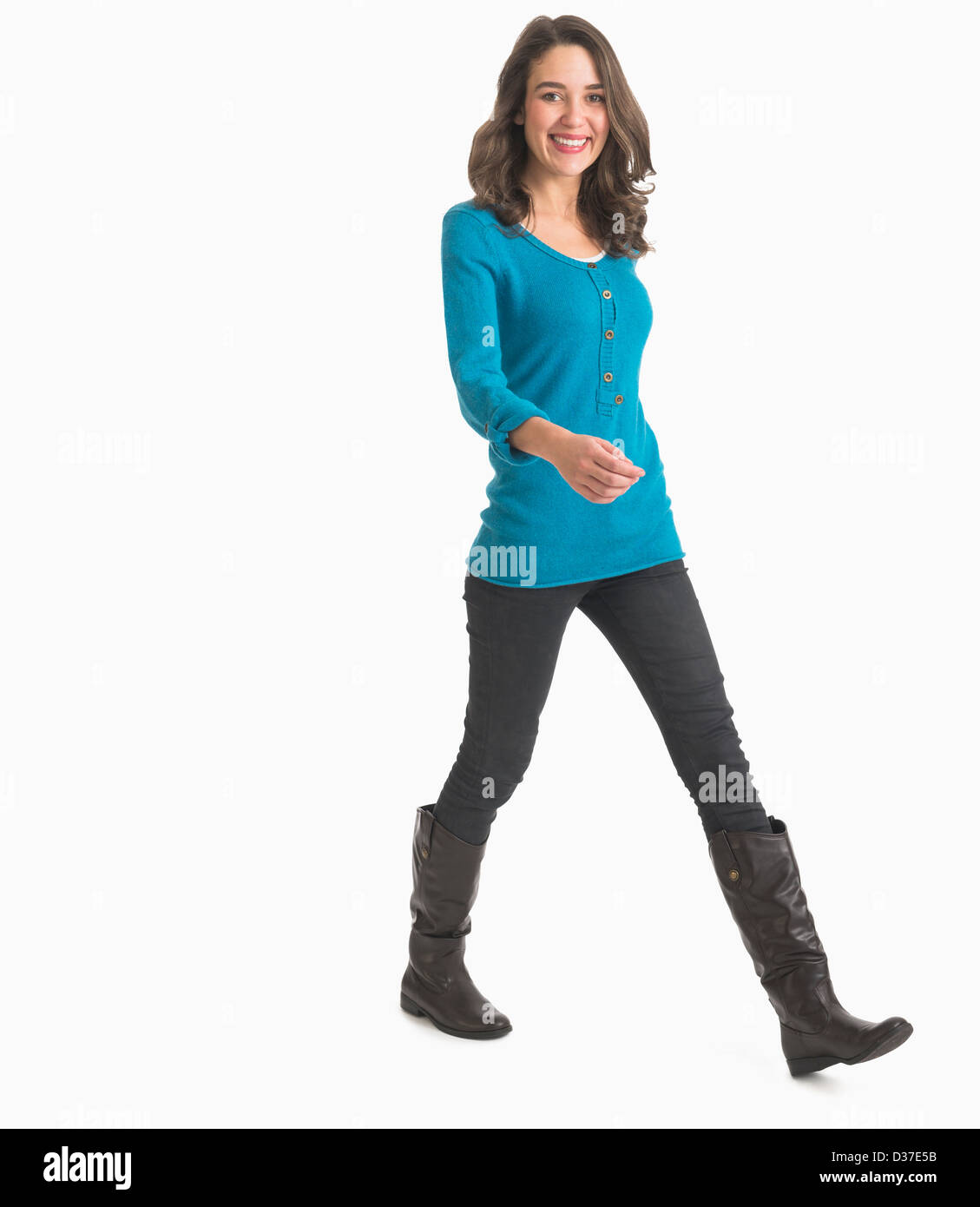 Studio shot of young woman walking Stock Photo - Alamy