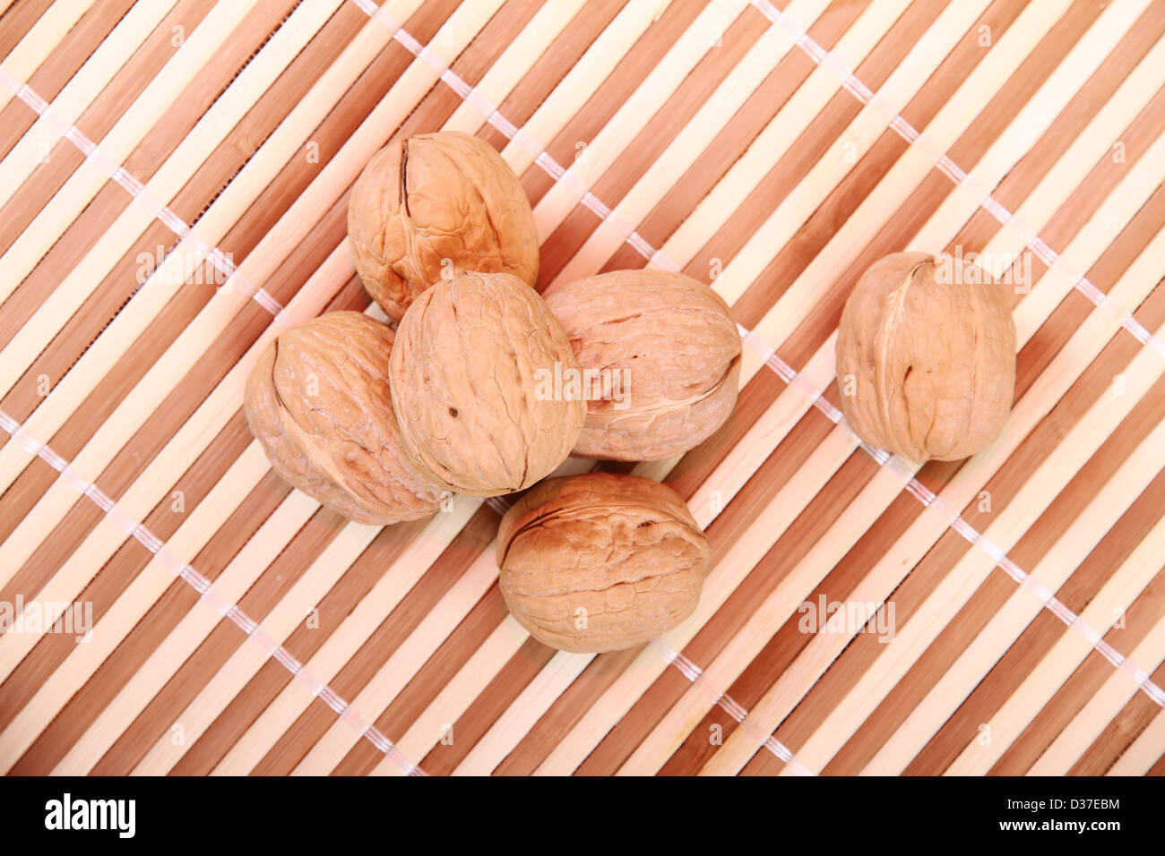 Some walnuts on a bamboo background Stock Photo - Alamy