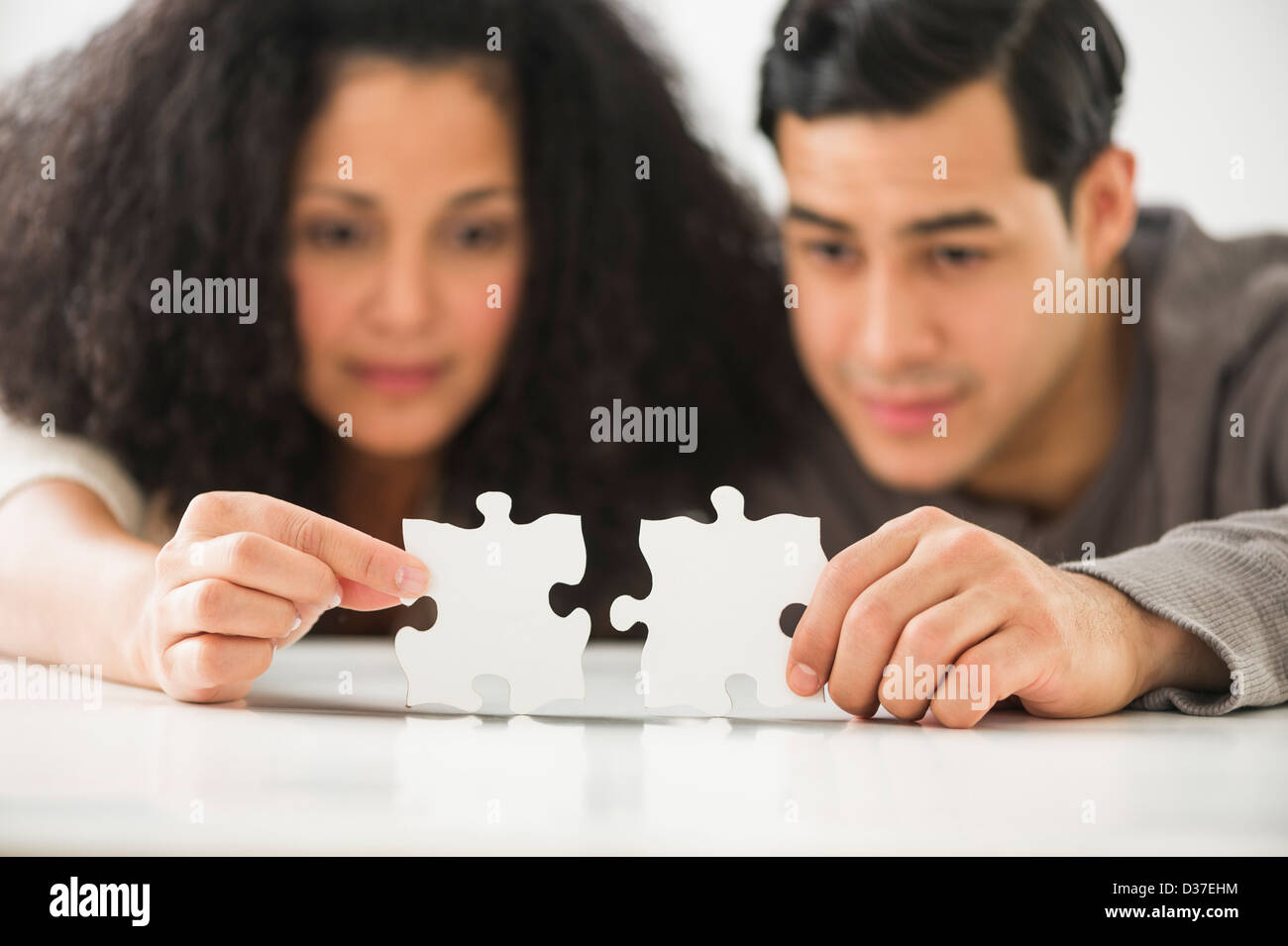 USA, New Jersey, Jersey City, Couple matching jigsaw puzzle Stock Photo ...