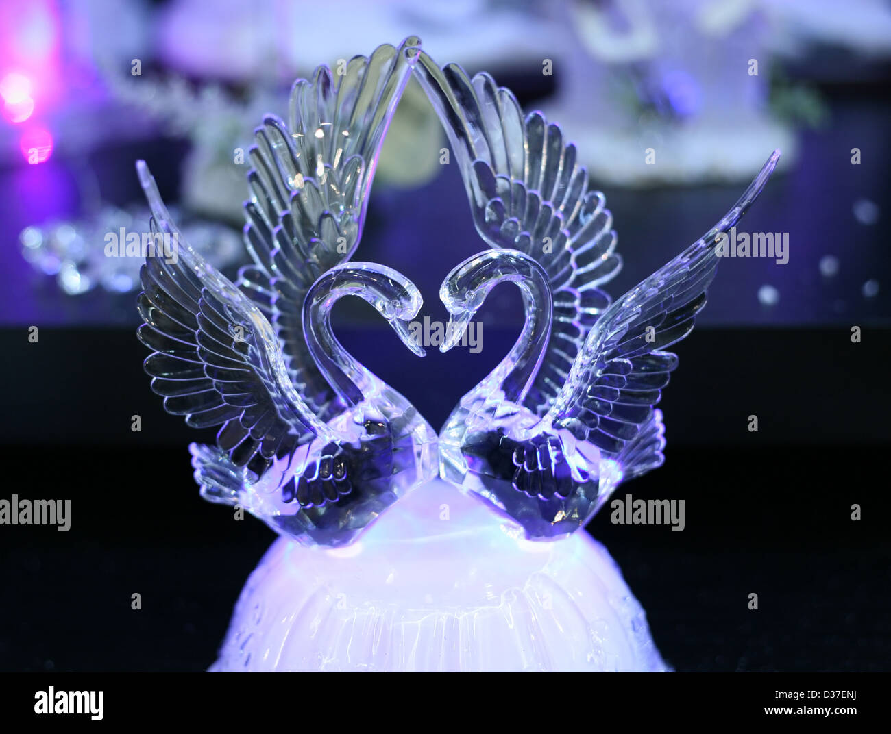 Crystal swans on a dark background Stock Photo - Alamy