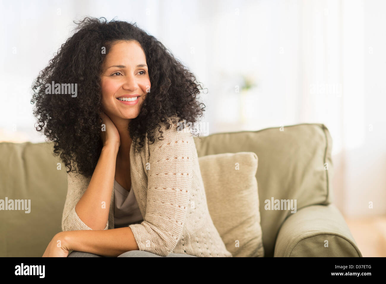 Sitting smiling looking away hand on chin hi-res stock photography and ...