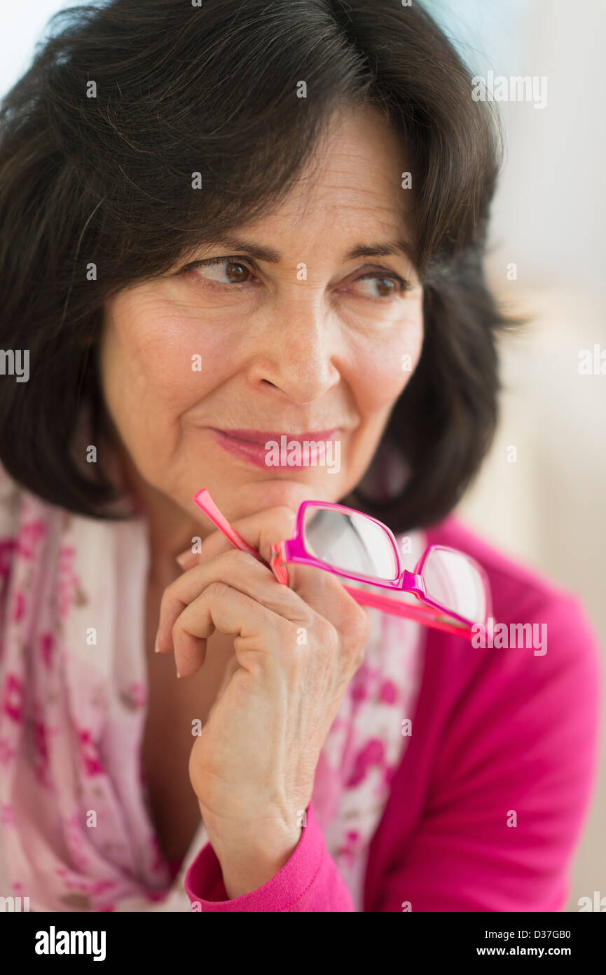 USA, New Jersey, Jersey City, Portrait of senior woman wearing pink ...