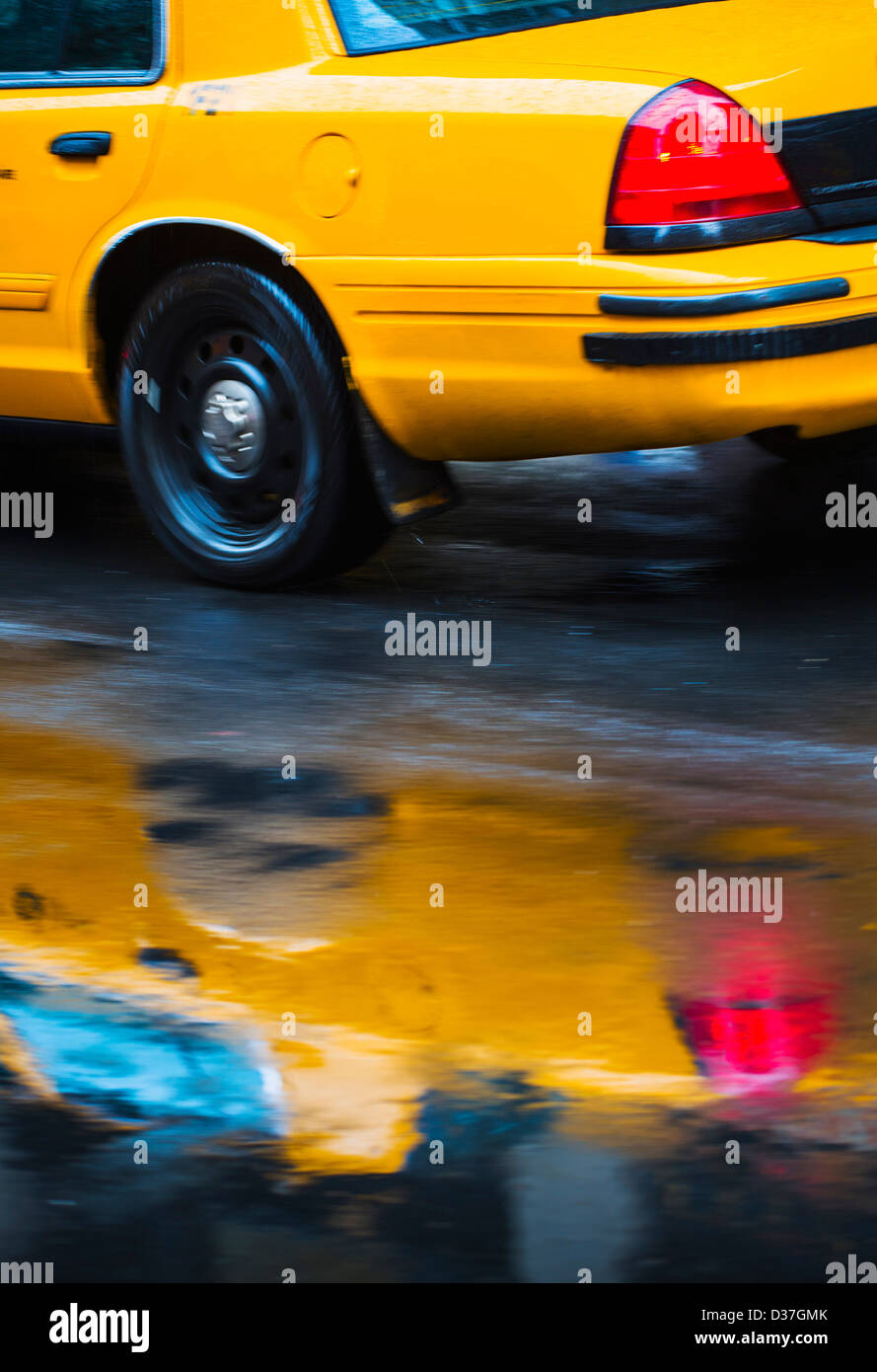 USA, New York City, Yellow cab reflecting in rain puddle Stock Photo ...