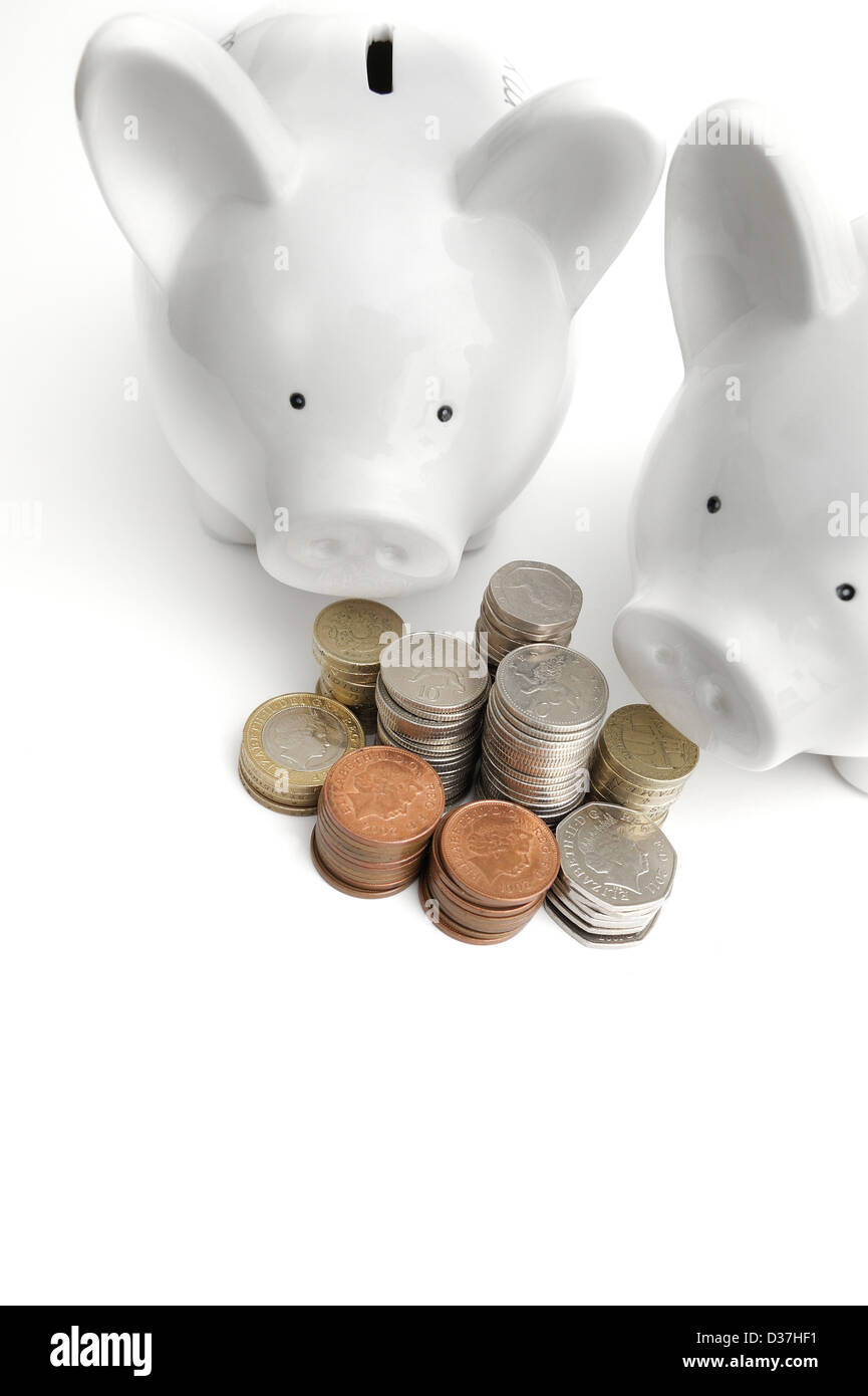 two piggy banks with english currency coins Stock Photo - Alamy