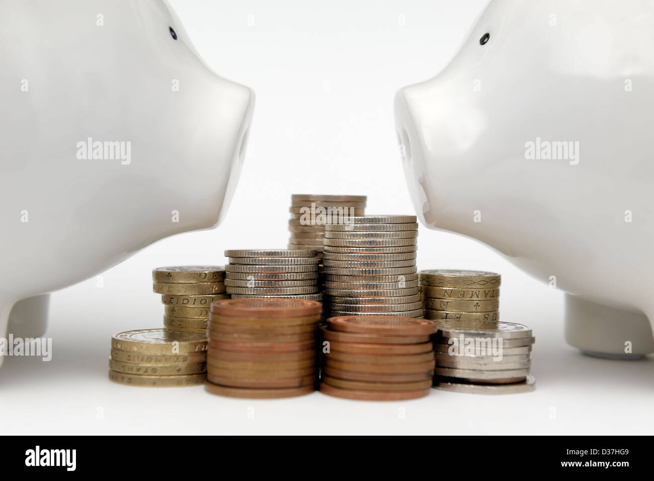 two piggy banks with english currency coins Stock Photo - Alamy