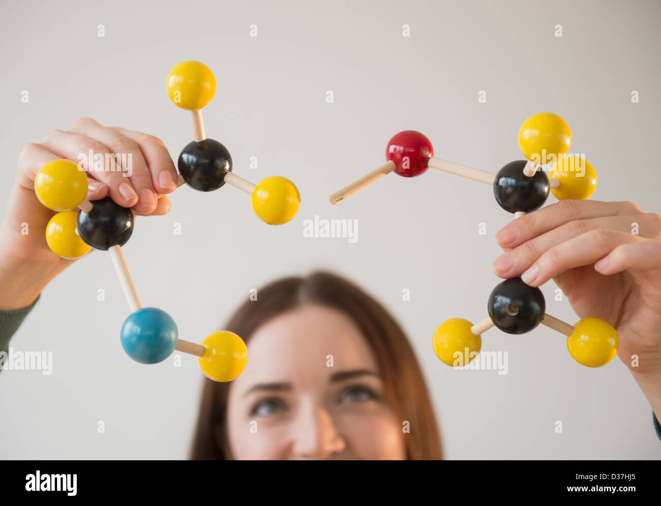 Young woman holding molecules model Stock Photo - Alamy