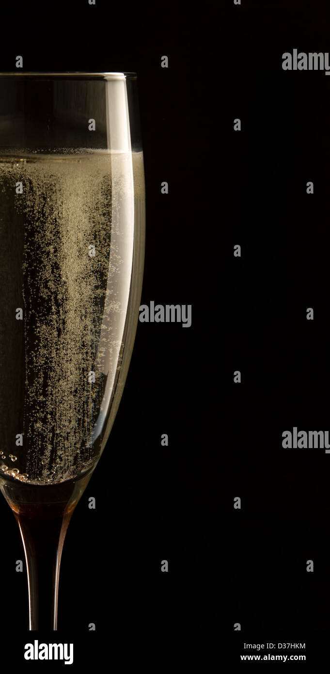 Champagne in glass on black background Stock Photo - Alamy