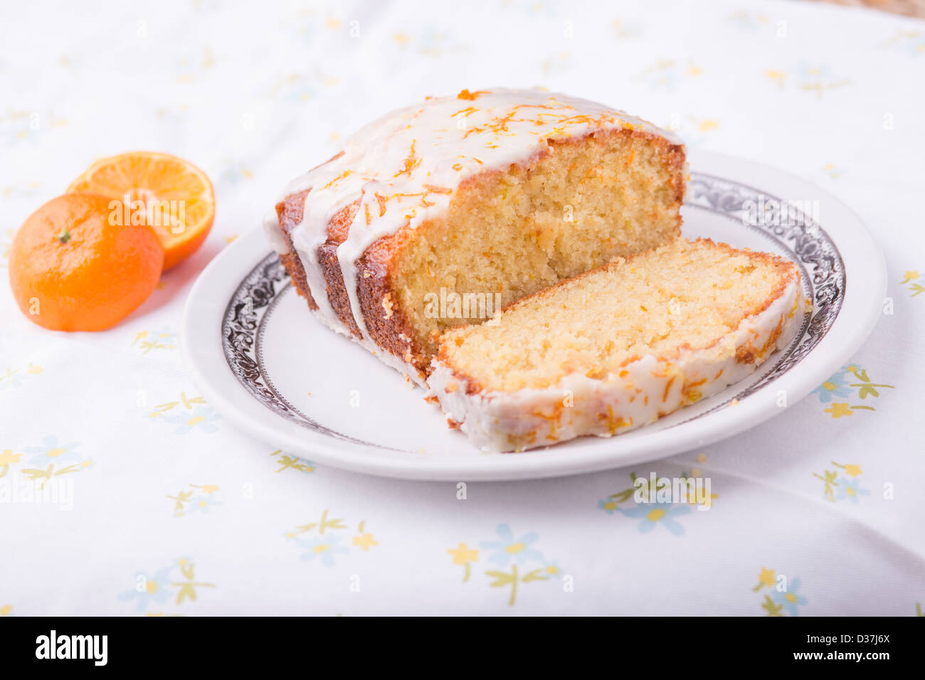 Citrus lemon orange clementine drizzle iced sponge cake homemade on a ...
