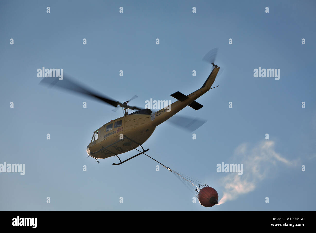 A Fire Rescue helicopter responds quickly to a fast spreading bush fire ...