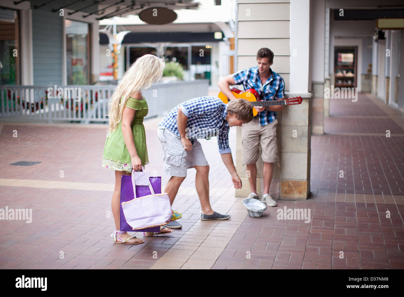 Woman giving money busker hi-res stock photography and images - Alamy