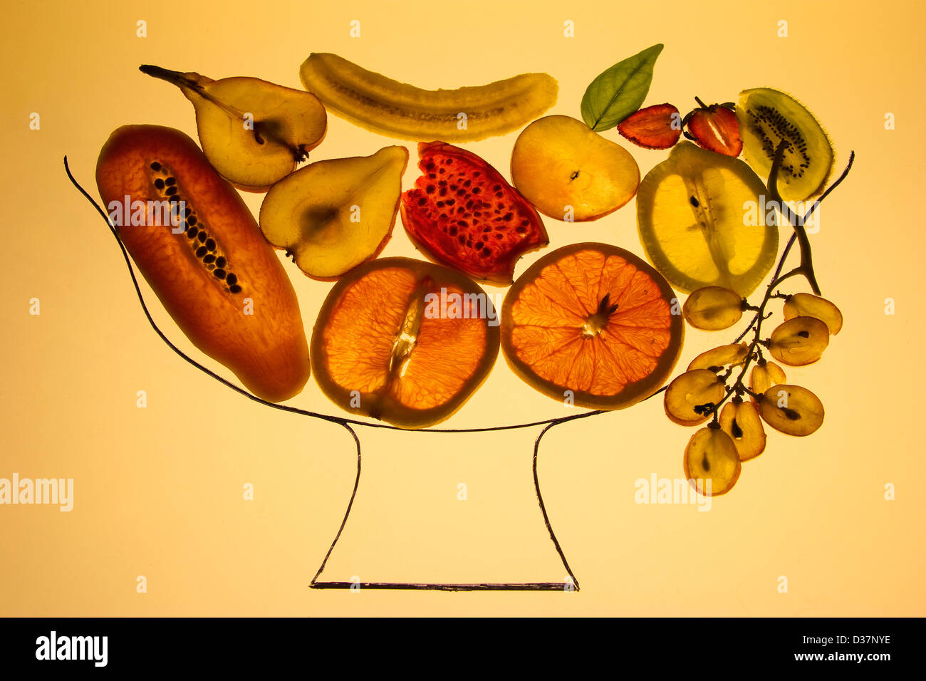 Sliced fruit in an imaginary bowl taken in the studio with light ...