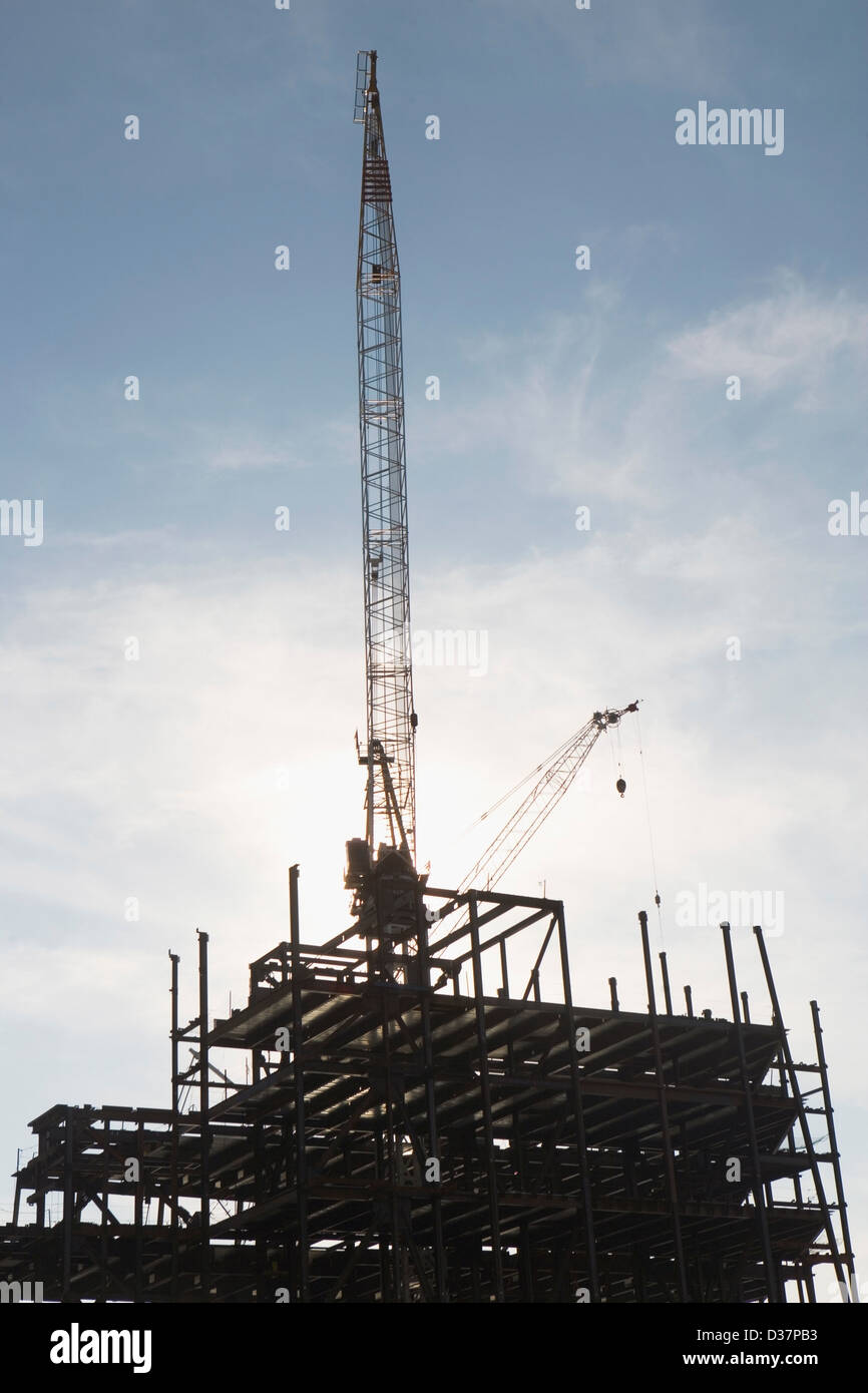Crane over building under construction Stock Photo - Alamy