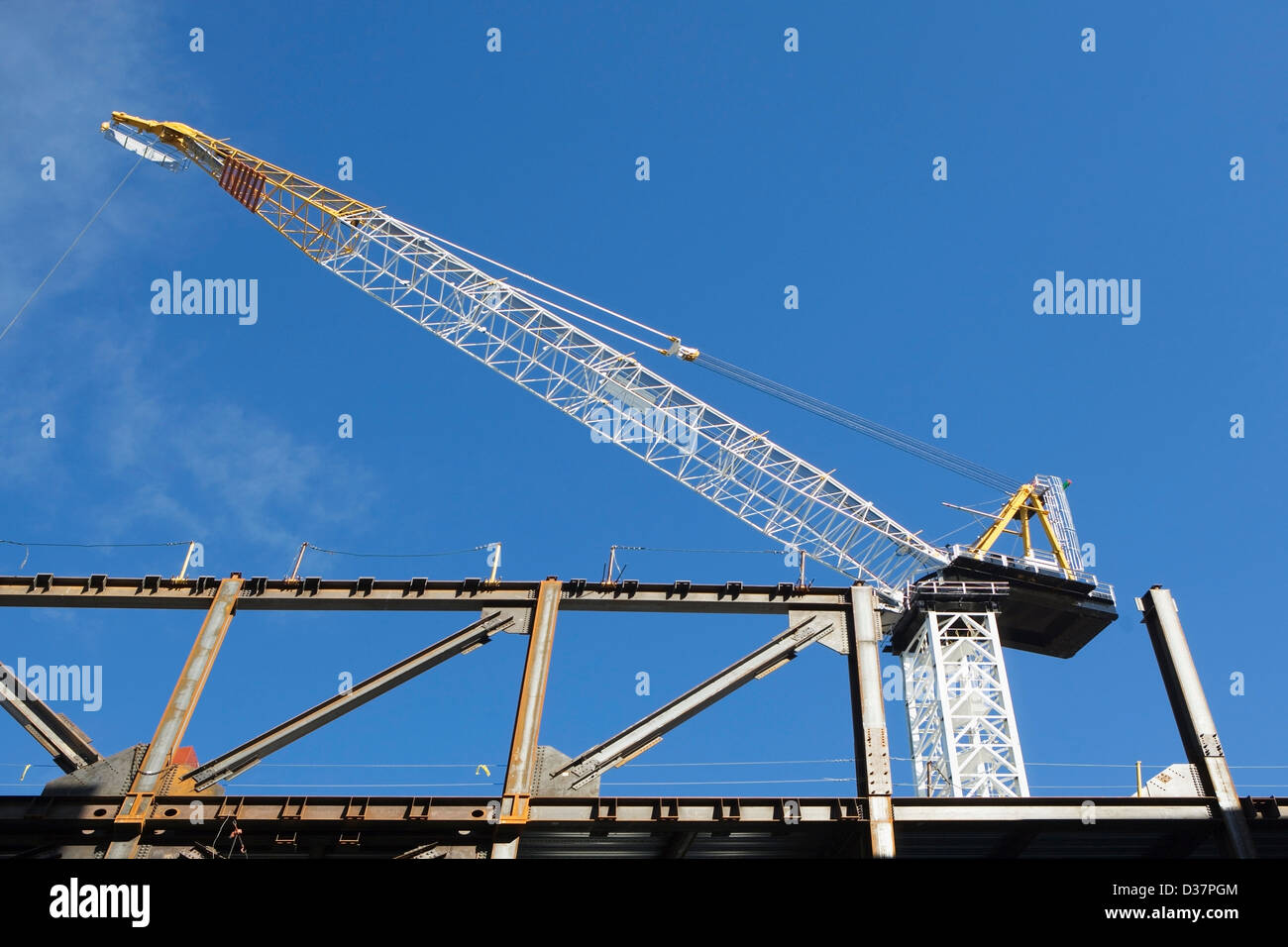 Low angle view of crane at construction site Stock Photo - Alamy