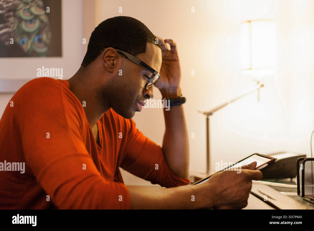 Man using tablet computer at desk Stock Photo - Alamy