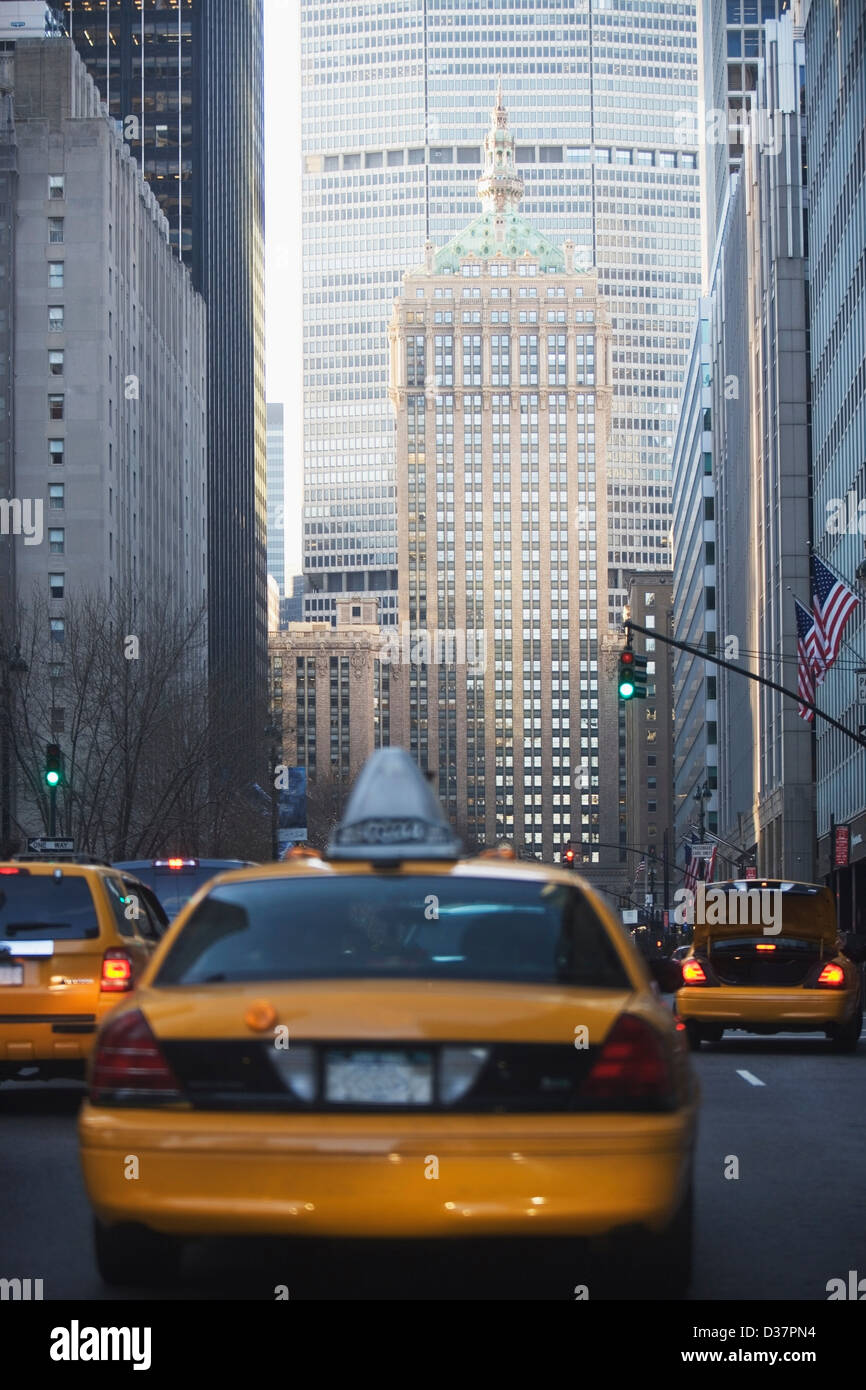 Taxis driving on city street Stock Photo - Alamy