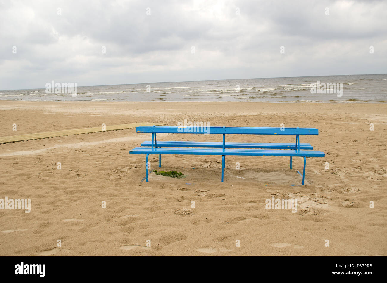 blue bench on sea ocean seaside beach sand in cloudy day Stock Photo ...