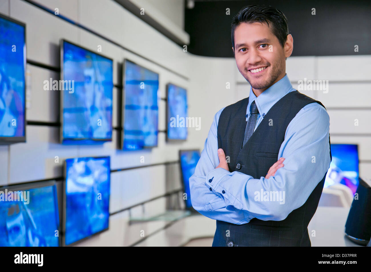 Salesman smiling in store Stock Photo - Alamy